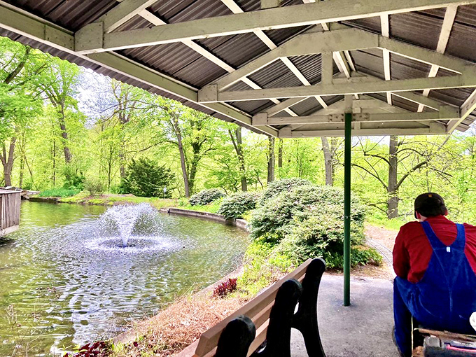 A serene pond with fountain offers a moment of reflection. The perfect spot to contemplate how far transportation technology has come since the steam age.