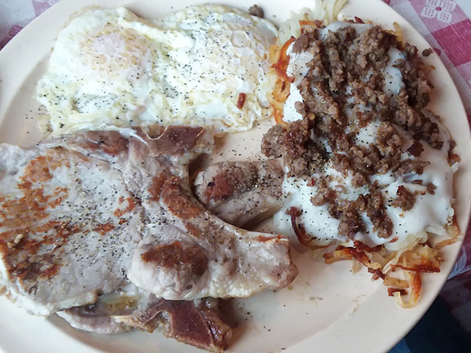 Pork chops, eggs, and hash browns sharing a plate like old friends at a reunion&mdash;simple food done right is culinary poetry.