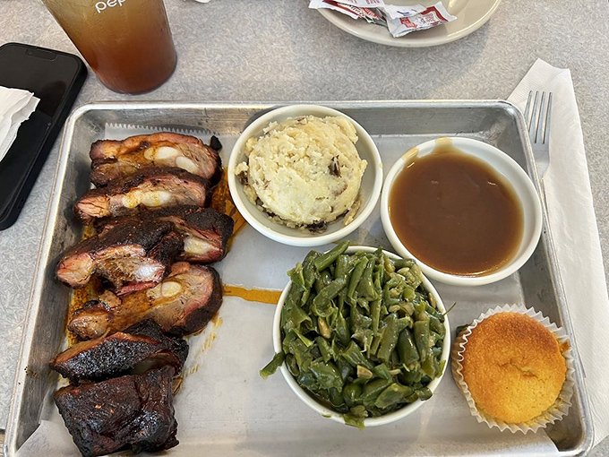 Ribs with bark so perfect they deserve their own trophy, paired with sides that understand their supporting role in this meaty masterpiece.