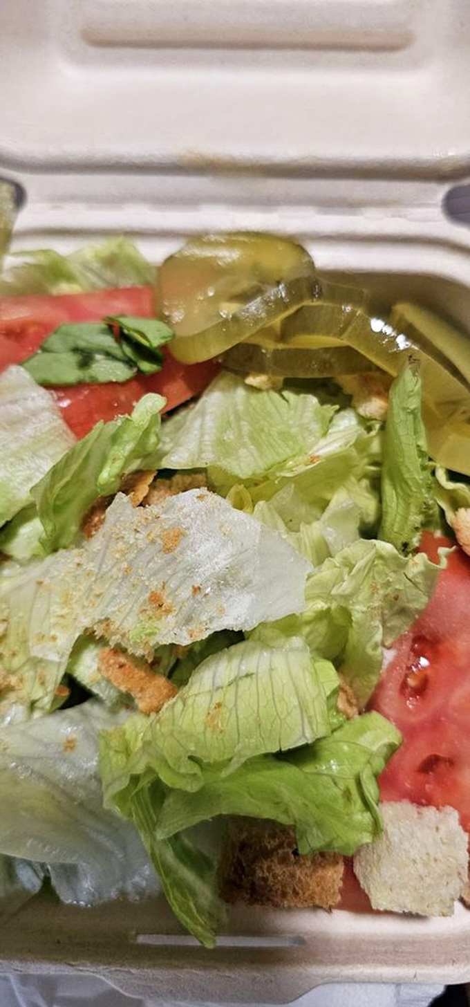 Even the side salad gets special attention&mdash;crisp lettuce, juicy tomato, and pickle slices that add the perfect tang to cut through burger richness.