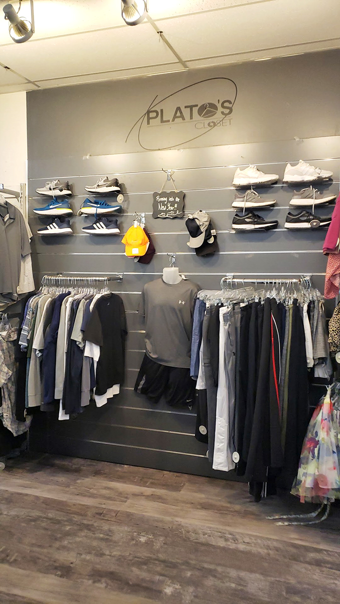 Gray walls and strategic lighting create a boutique feel that elevates the secondhand shopping experience beyond typical thrift stores.