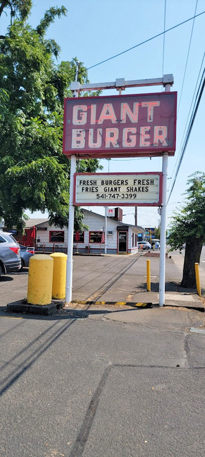 The sign promises "Fresh Burgers, Fresh Fries, Giant Shakes" &ndash; three simple commitments that have kept customers returning for decades.