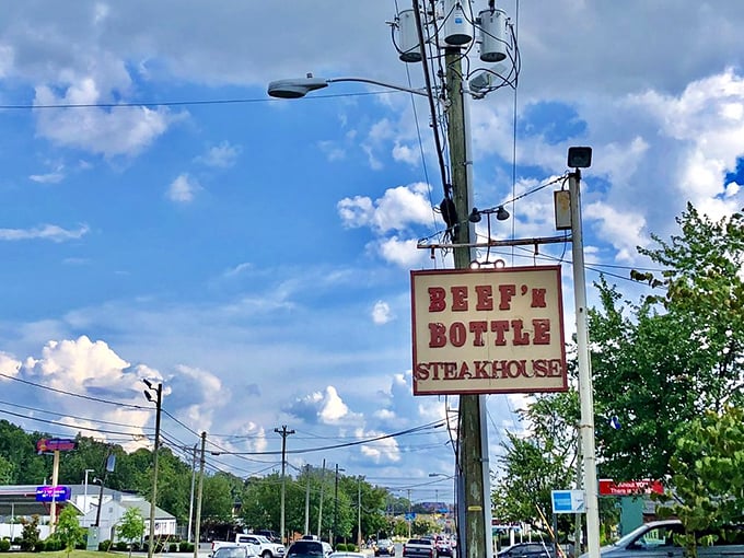 The roadside sign stands tall against Carolina blue skies, a beacon guiding hungry travelers to beef salvation since the Eisenhower administration.