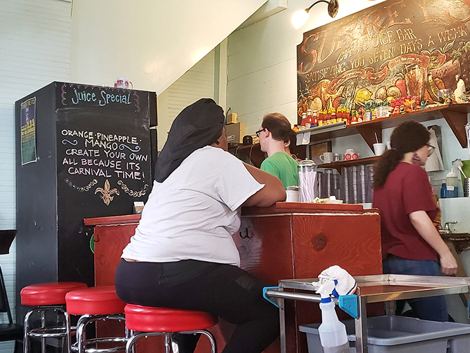Behind the counter, Surrey's staff orchestrates the morning's culinary symphony, with fresh juice specials announced on the chalkboard.