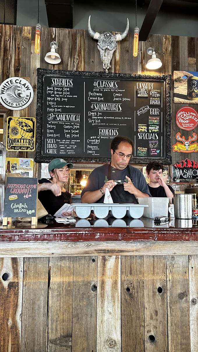 The sandwich artisans at work, focused with the intensity of brain surgeons. Their canvas? Rye bread. Their medium? Perfectly cured meats.