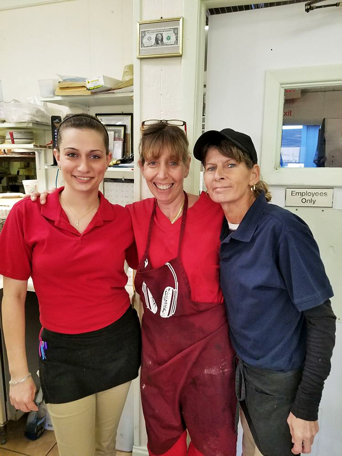 The secret ingredient in every great restaurant? The people. These smiling faces are the reason regulars keep coming back for "just one more slice."