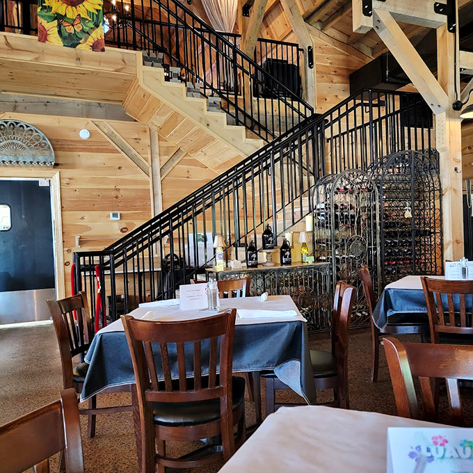 That staircase leads to more seating, but the real elevation happens on your plate. Notice the wine storage&mdash;priorities in order!