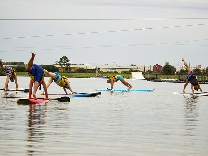 Yoga meets water sports as paddleboarders perfect their downward dog. Finding balance on water adds a whole new dimension to "core strength."