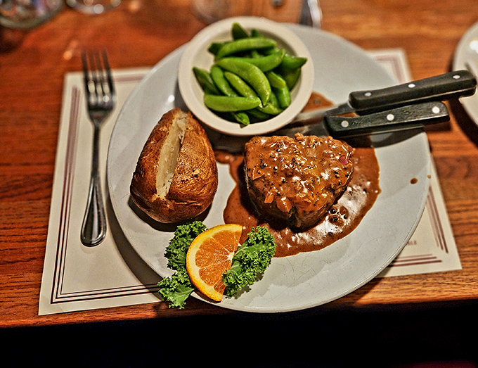 A perfectly cooked steak with peppercorn sauce and a baked potato. Even at a seafood restaurant, the turf holds its own against the surf. 
