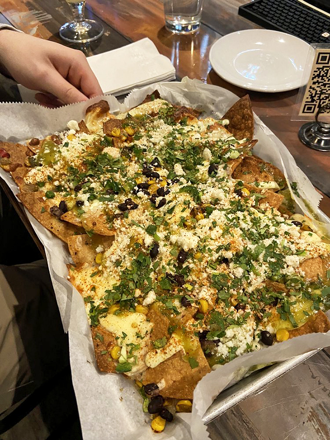 These loaded nachos aren't messing around&mdash;cheese, corn, herbs, and who knows what other treasures are buried in this mountain of deliciousness.