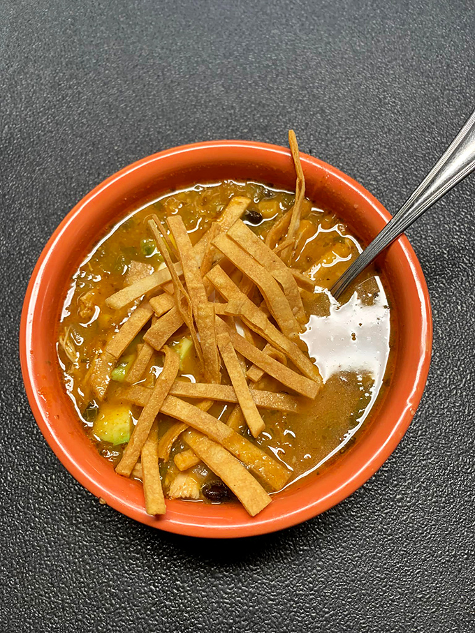 Tortilla soup that's both hearty and bright, with crispy strips creating texture in every spoonful of this liquid comfort.