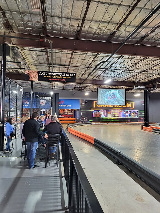 Spectators lean in at the track's edge, their conversations punctuated by the whoosh of karts and occasional victory whoops.