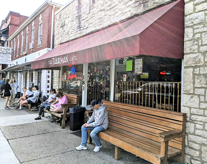 The wooden benches outside serve as both waiting area and recovery zone for those who've just experienced the full Thurman effect.