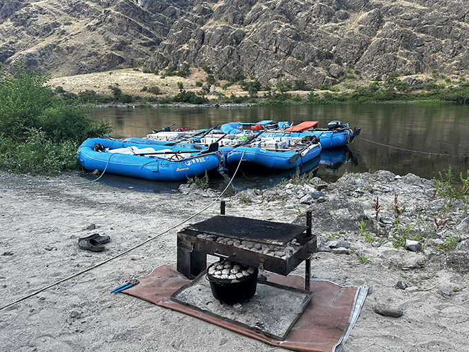 River rafts resting before their next adventure&mdash;that campfire setup promising stories that improve with each telling as the sun sets.