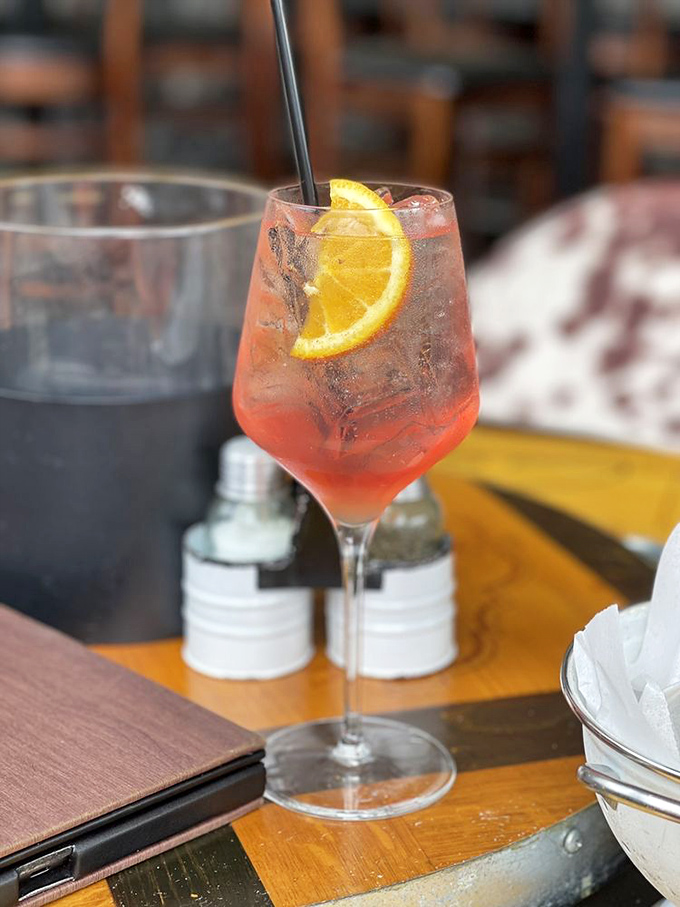 A cocktail that looks like a Maryland sunset in a glass, complete with a citrus garnish that's not just for show&mdash;it's part of the experience.