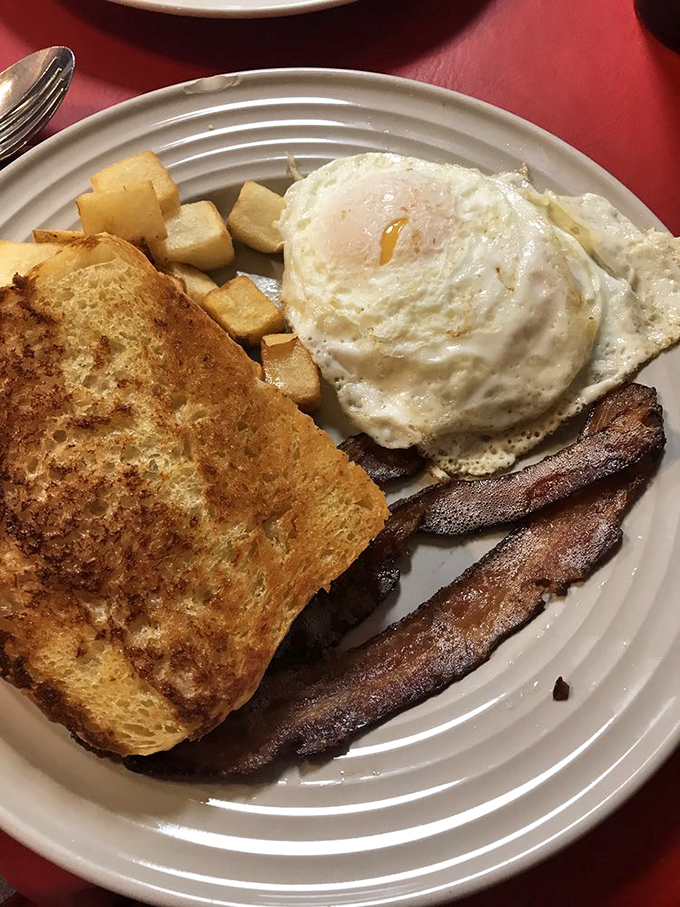 Breakfast of champions: golden toast, farm-fresh eggs with that perfect runny yolk, crispy bacon, and home fries that put hash browns to shame.