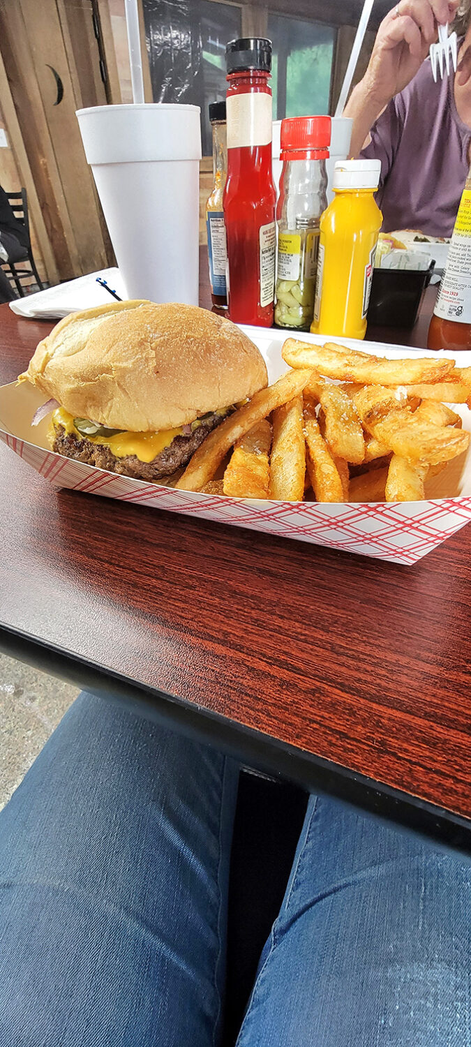The classic cheeseburger and fries&mdash;America's most perfect food pairing, served without irony or apology on a red checkered paper.