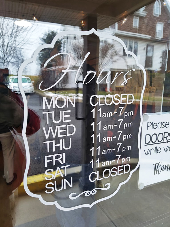 Business hours carved in white on glass&mdash;memorize them to avoid the heartbreak of arriving when the smokers are silent.