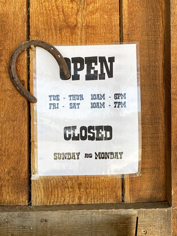 Even the hours sign hangs with rustic charm—that horseshoe isn't just decoration, it's holding all the good luck for your meal.