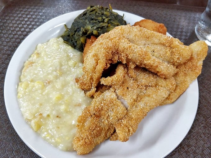 Cornmeal-crusted catfish with the perfect golden exterior, creamy grits, and collards&mdash;the holy trinity of Southern plate lunches.