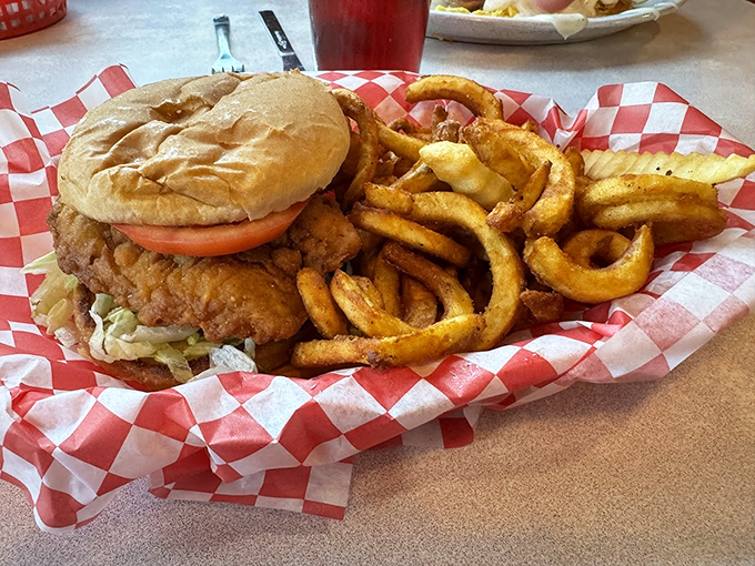 This chicken sandwich with curly fries isn't just a meal, it's therapy on a red-checkered paper. Comfort food that speaks a universal language.