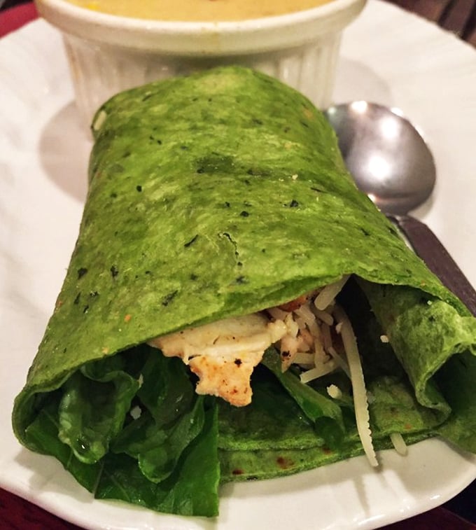 That spinach wrap isn't just lunch&mdash;it's a portable garden party. The vibrant green exterior hints at the fresh goodness tucked inside.