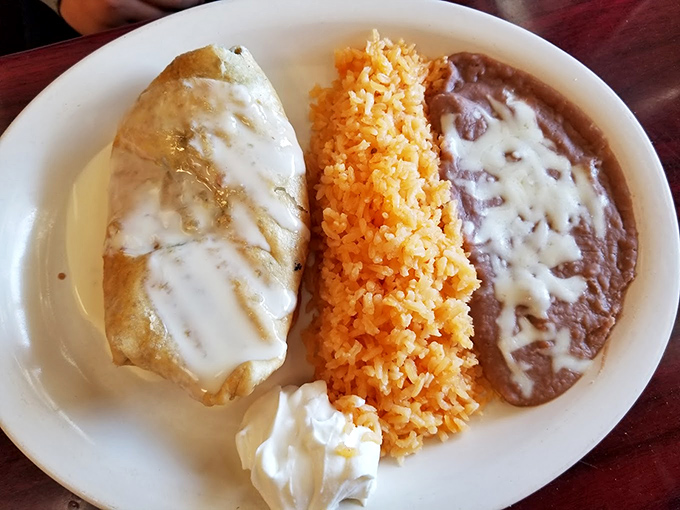 A chimichanga that's achieved the impossible dream—crispy exterior giving way to a steamy, flavor-packed interior, accompanied by the holy trinity of rice and beans.