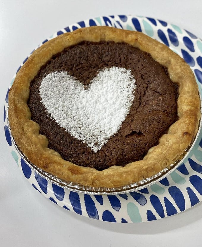 A chocolate chess pie with a powdered sugar heart says what words can't: "I love you, but I love this pie enough to share it with you."