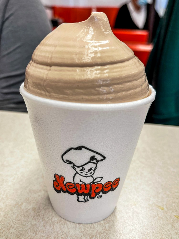 The chocolate malt stands tall and proud, its perfect swirl reaching skyward like a monument to dairy excellence that requires serious straw strength.