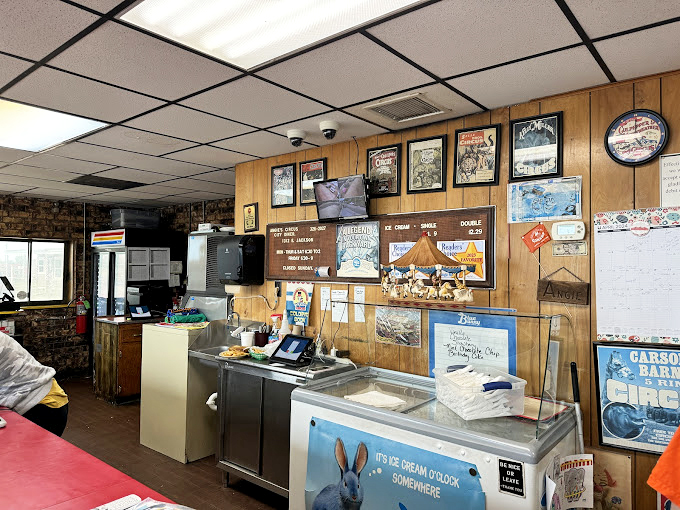 Order at the counter and watch the choreographed kitchen ballet. The circus posters overhead remind you this isn't just any small-town diner.