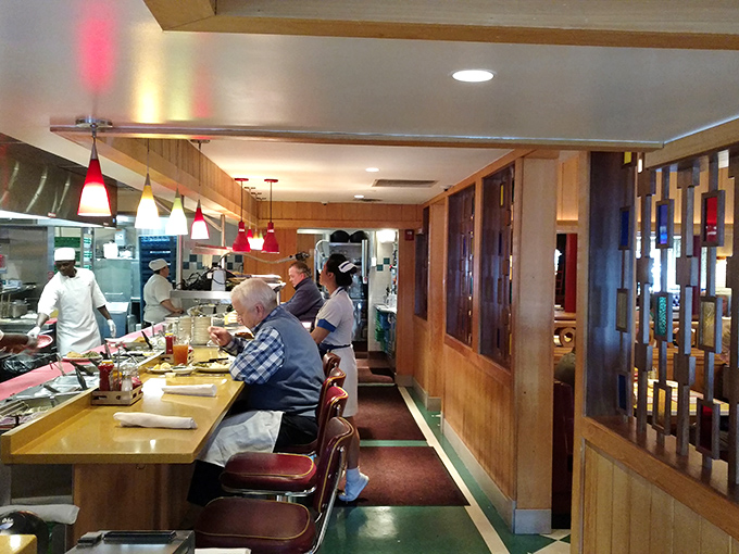 Where the counter becomes front-row seating to the greatest show on earth: American diner culture in full, glorious swing.