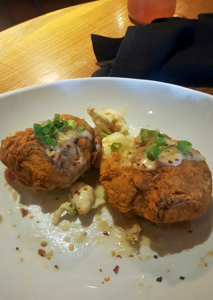 These golden-fried crab cakes with their creamy sauce aren't just appetizers &ndash; they're little discs of seafood perfection.