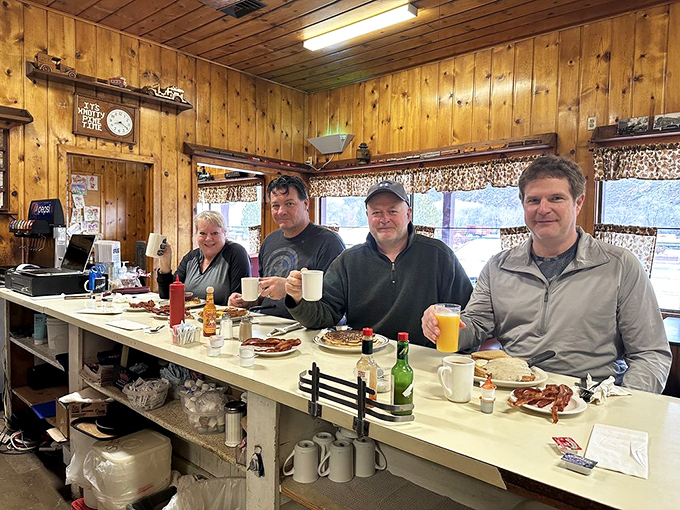 Happy customers raising coffee mugs like trophies&mdash;the universal signal that breakfast is doing exactly what it's supposed to do.