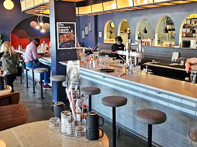 The curved bar with its distinctive arched windows isn't just functional&mdash;it's the social heart of Mercury, where strangers become friends over coffee. 