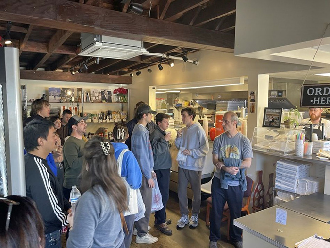 The lunch rush at Ideal's&mdash;hungry humans united in sandwich anticipation. Some quests are worth standing in line for.