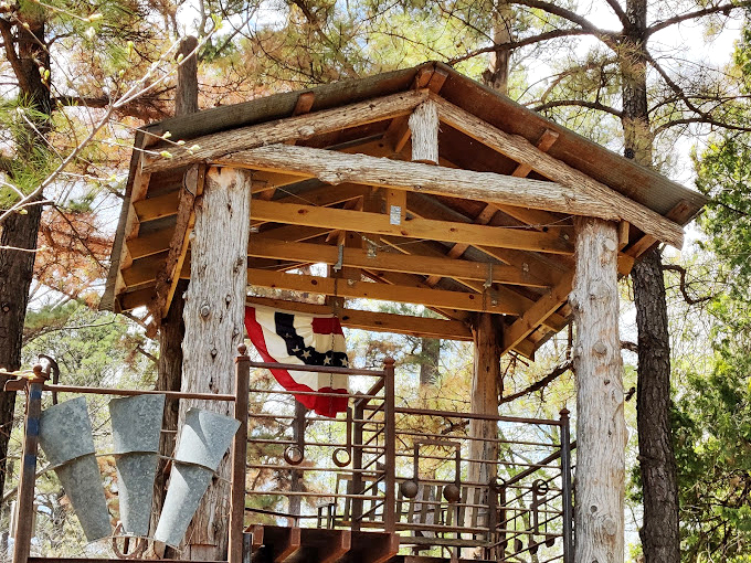 The rustic platform offers a different perspective on the gardens below, proving sometimes you need to go up to truly appreciate what's down.