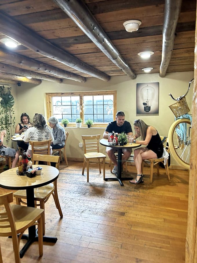 The interior transports you to someone's mountain cabin, where wooden beams and warm lighting make even strangers feel like regular customers.