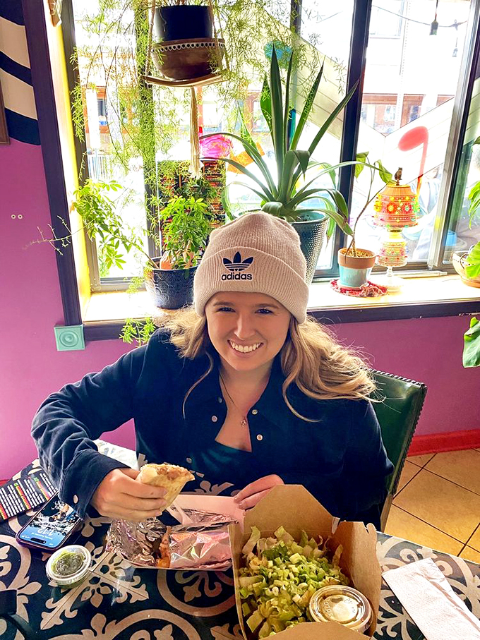 Happy diners experiencing that moment of taco bliss. The colorful decor creates the perfect backdrop for food that demands to be photographed before it's devoured.