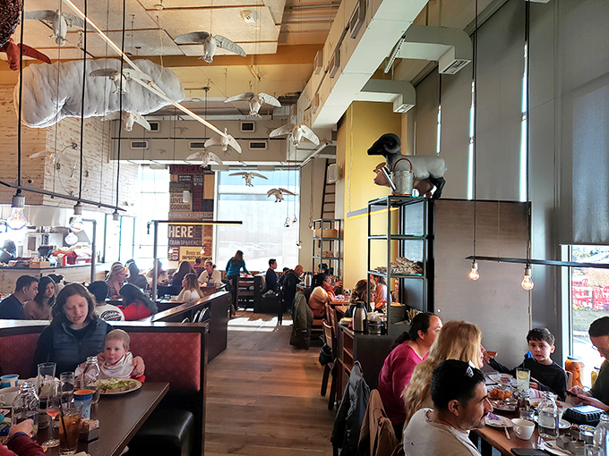 The bustling dining room hums with conversation and clinking plates. Families and friends gather under quirky farm-inspired d&eacute;cor for memorable meals.