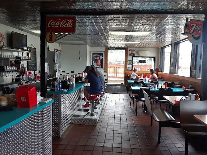 Where locals gather to solve the world's problems over eggs and coffee, creating the beautiful choreography of American diner culture.