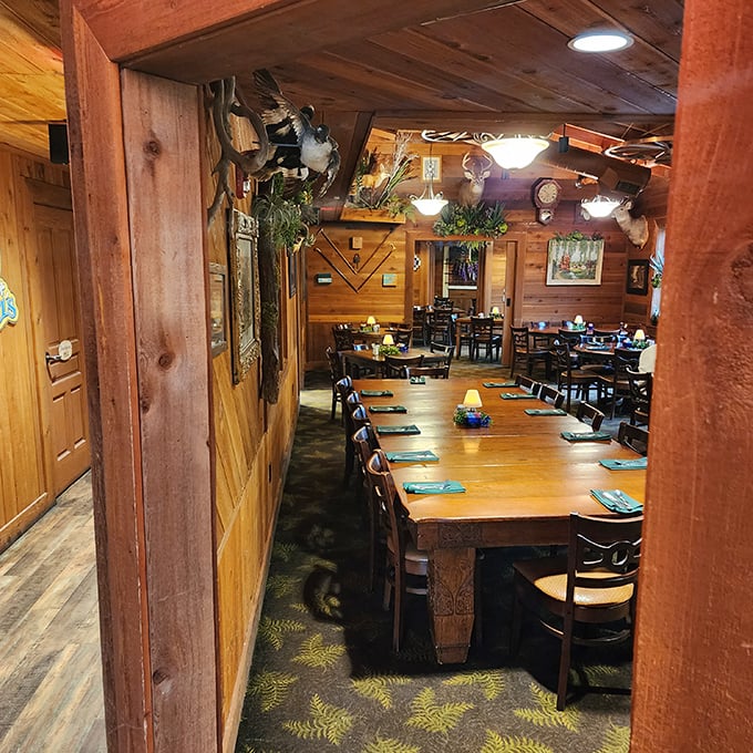 Rustic wooden dining tables beneath mounted wildlife create the perfect setting for stories that grow taller with each delicious bite.
