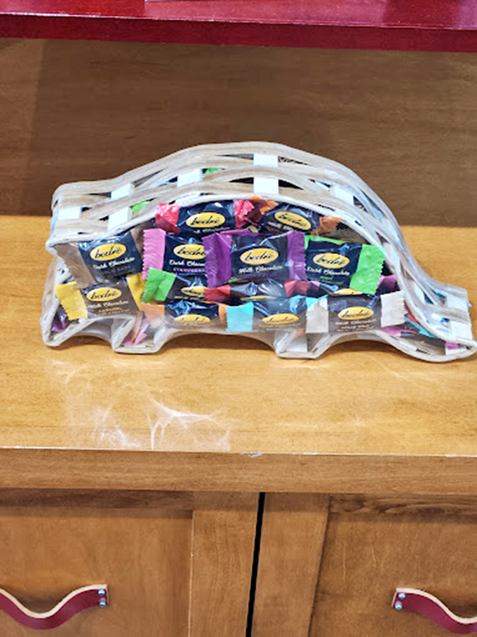 A prehistoric-shaped container filled with modern delights&mdash;proving dinosaurs didn't die out, they just evolved into chocolate delivery systems.