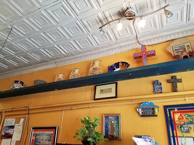 A shrine to Mexican craftsmanship lines the wall &ndash; ceramic pieces and religious symbols telling stories of heritage and tradition that influence every dish served.