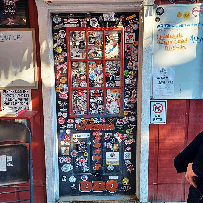 A door covered in stickers and memories—each one representing another pilgrim who made the journey to BBQ paradise.