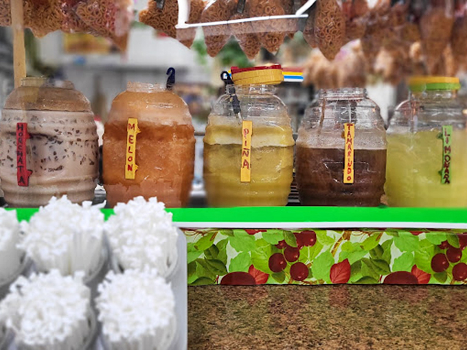 Homemade aguas frescas in mason jars&mdash;liquid refreshment that makes plain water seem like it's not even trying.