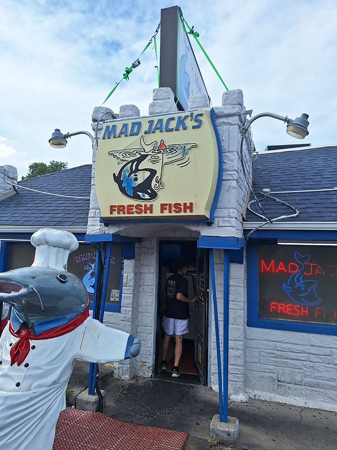 The entrance feels like stepping through a portal to seafood nirvana, complete with the smiling catfish chef standing guard.
