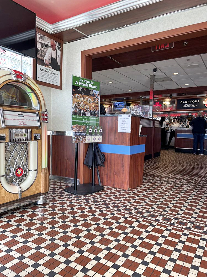 The entrance features that classic diner staple—the jukebox—standing guard like a chrome-plated sentinel of musical memories from simpler times.