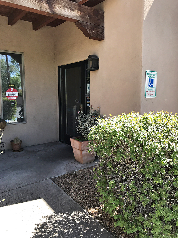 The entrance to donut nirvana, where that unassuming door might as well be labeled "Portal to Happiness." The potted plant can't contain its excitement.