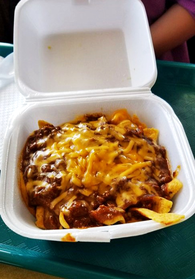 Frito chili pie in a to-go container&mdash;proof that comfort food doesn't need fancy presentation to hit all the right nostalgic notes.