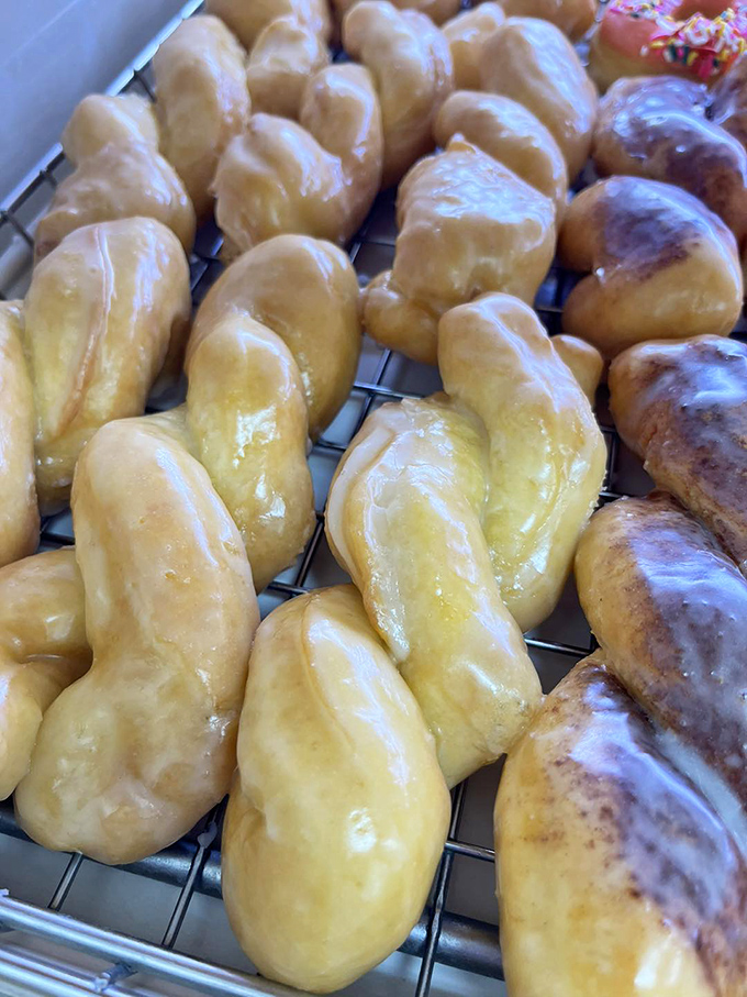 Glazed twist donuts glisten under the display lights, their elongated form offering more surface area for that sweet, shiny coating we crave.